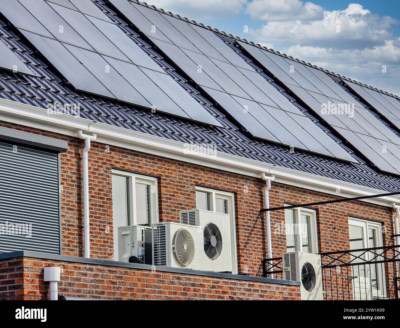 air source heat pump unit installed outdoors at a modern home with ...