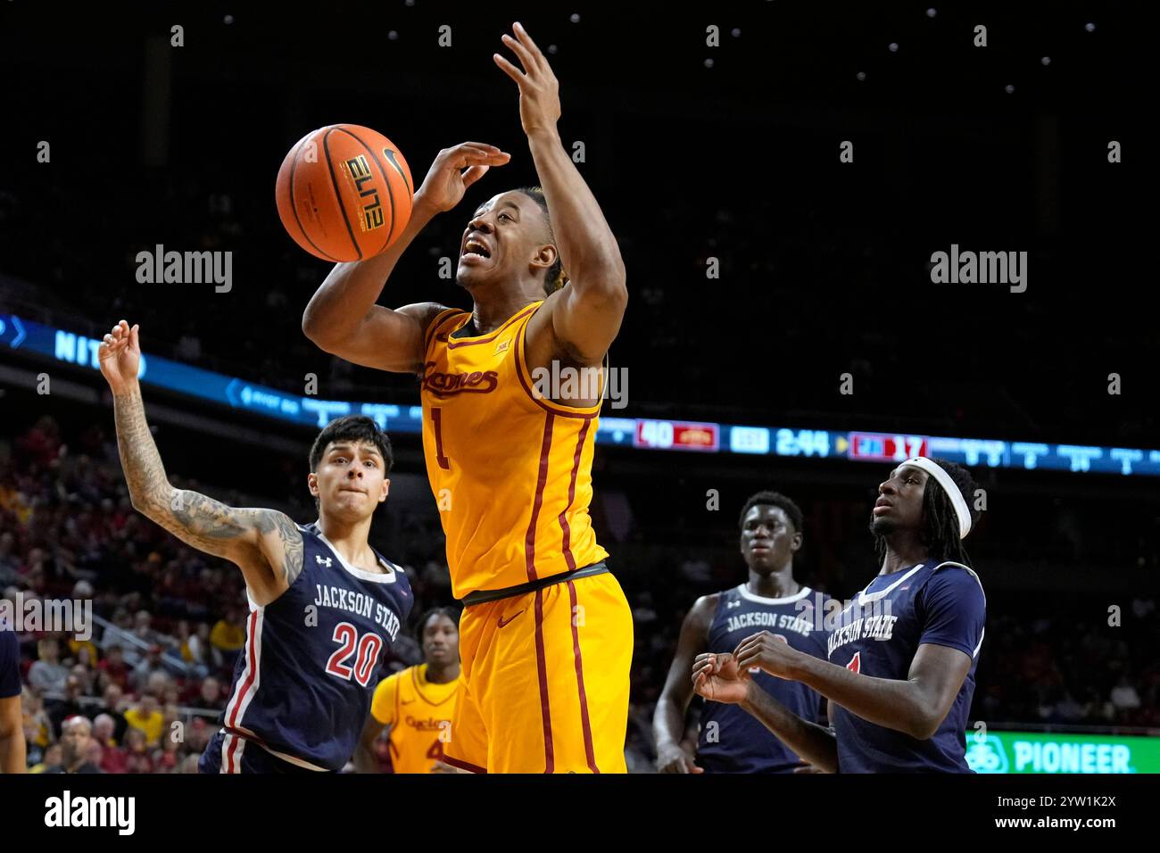 Iowa State center Dishon Jackson, center, loses the ball while driving ...