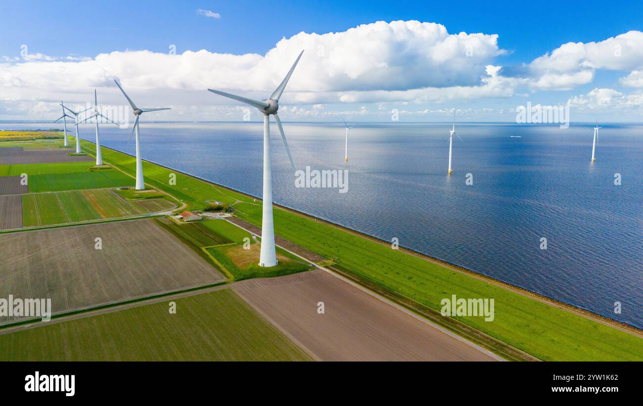 A mesmerizing aerial view of a wind farm near the ocean, where rows of ...