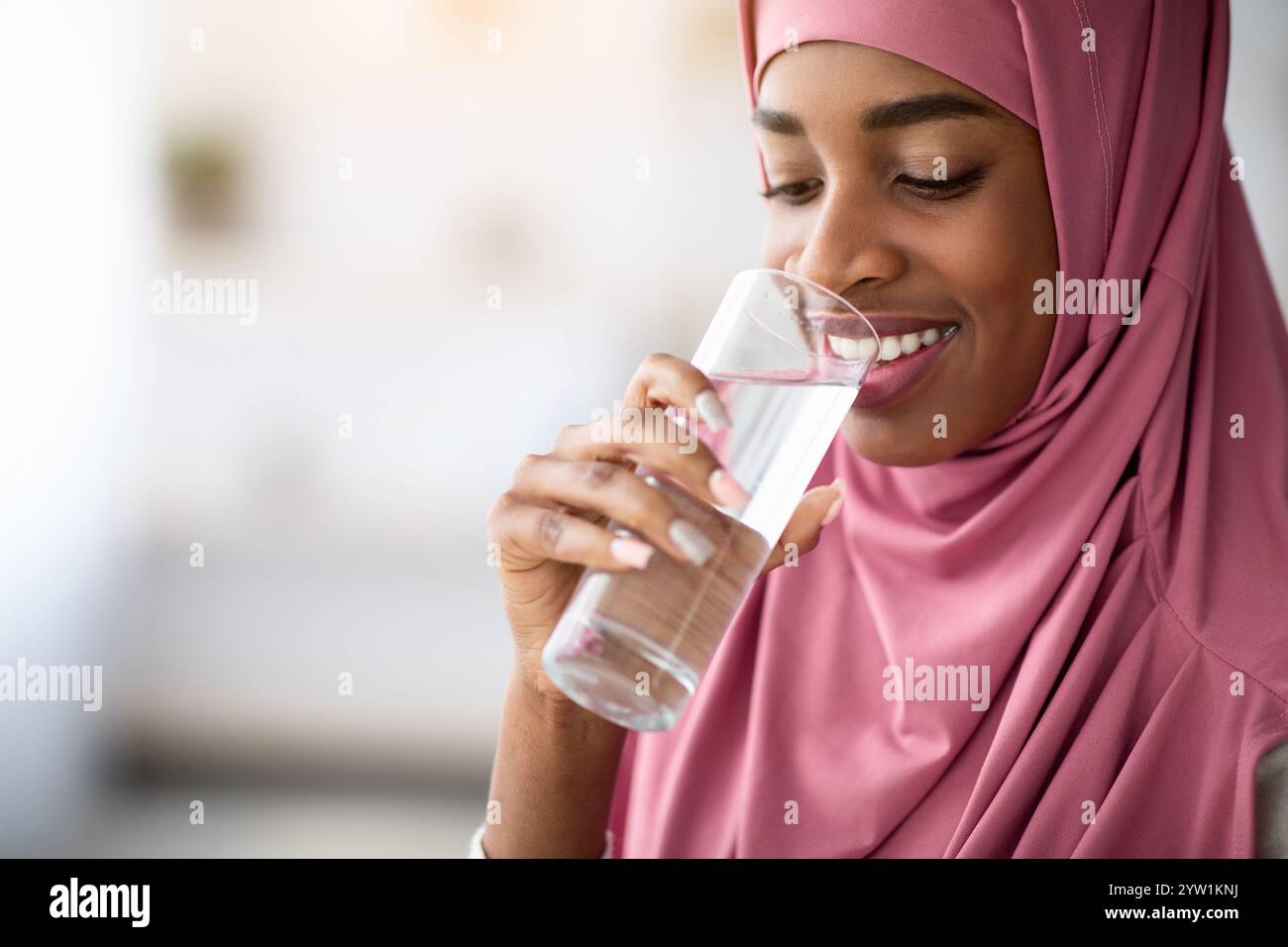 Black Muslim Woman In Hijab Drinking Water From Glass At Home, Closeup ...