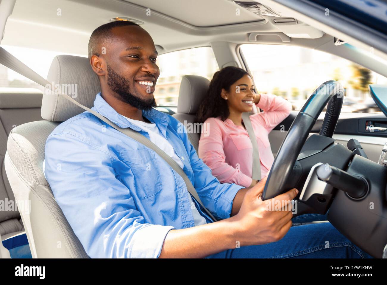 Happy black couple enjoying long drive on a car Stock Photo - Alamy