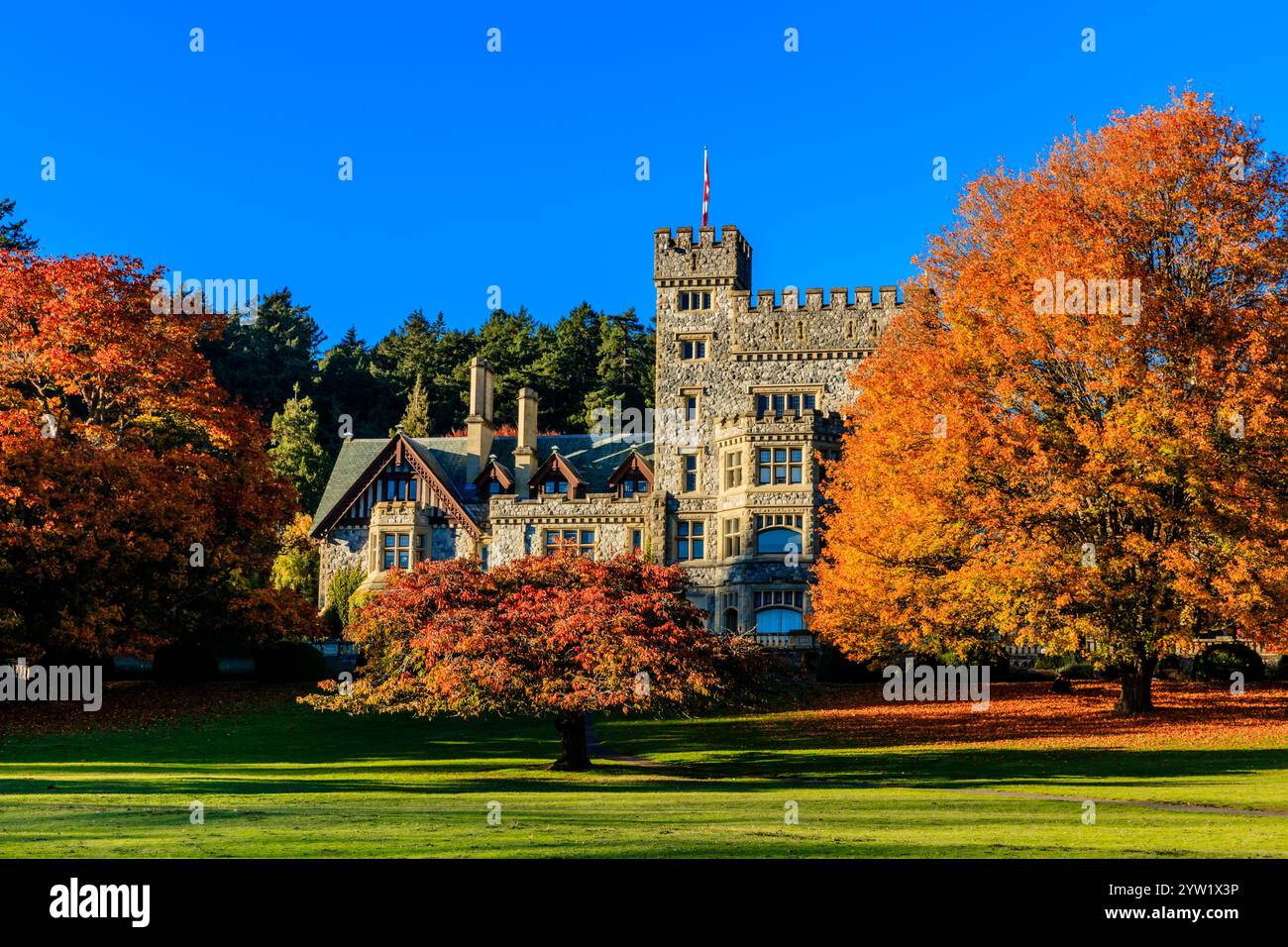 A large castle with a red and white flag on top. The castle is ...