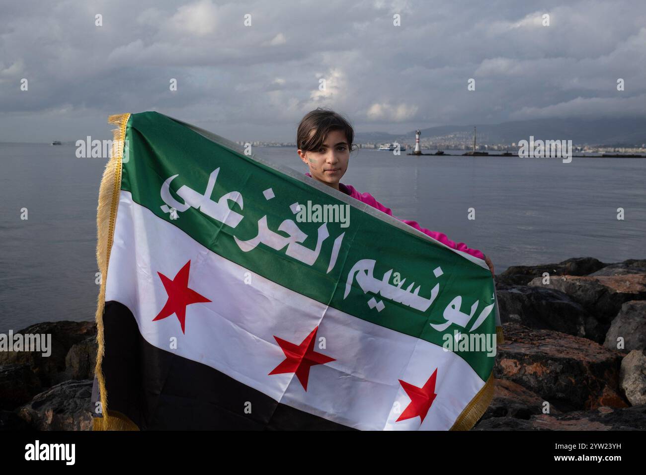 A Syrian girl holds a flag of the Syrian National Army. The fall of ...