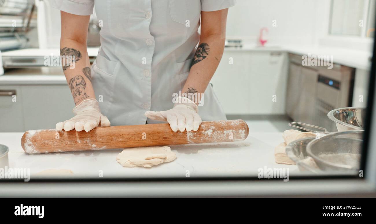 Rolling pin, bakery and dough with hands of person in kitchen for ...