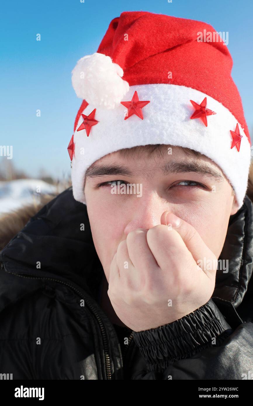 frozen young man in santa's hat in the winter Stock Photo - Alamy