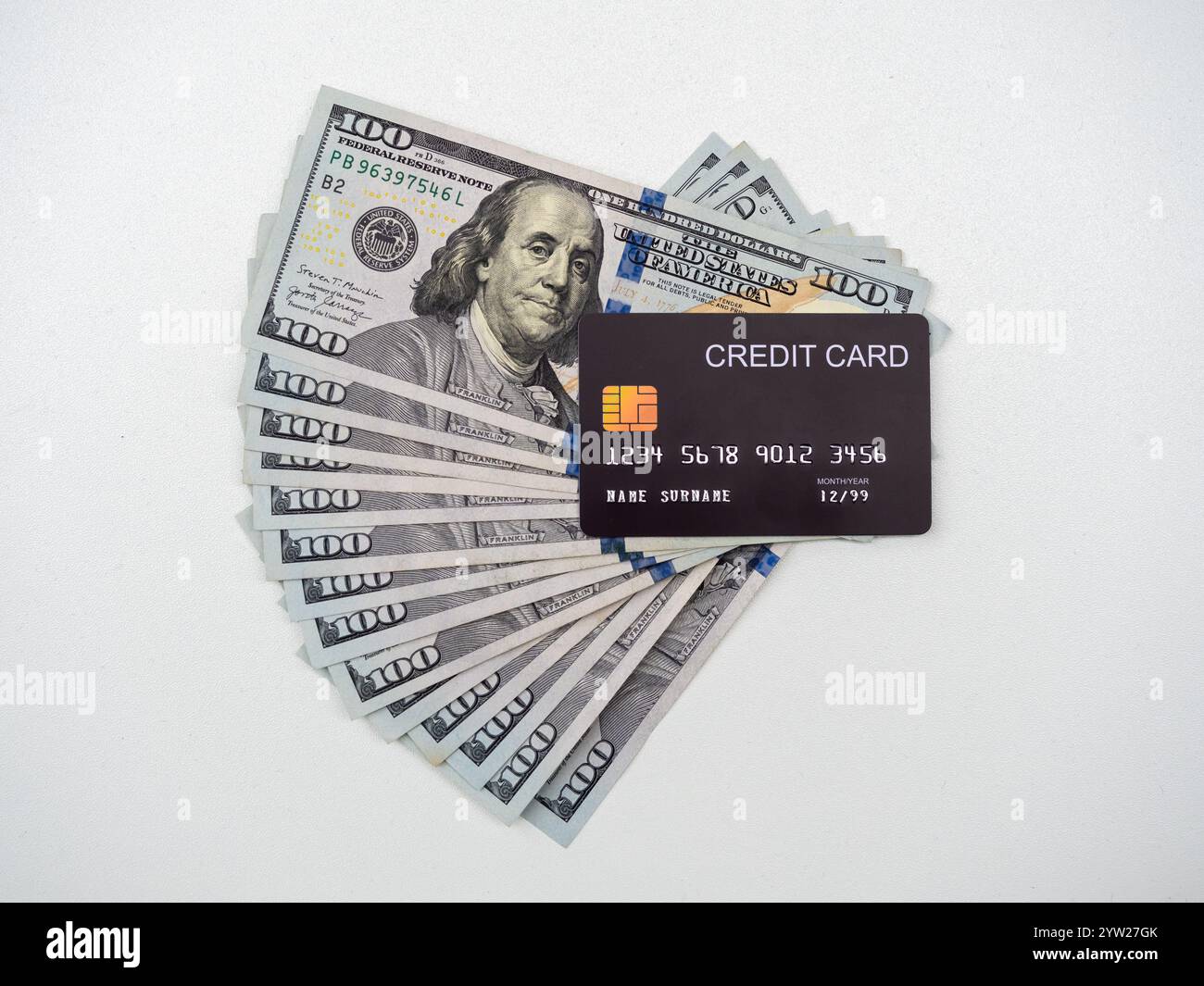 Fake black credit card on many 100 Dollar banknotes cash, isolated on ...