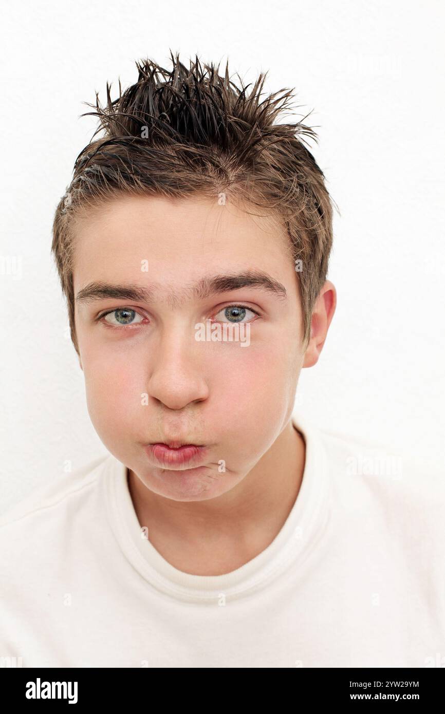 Funny Teenager inflate his cheeks on the White Wall background Stock ...