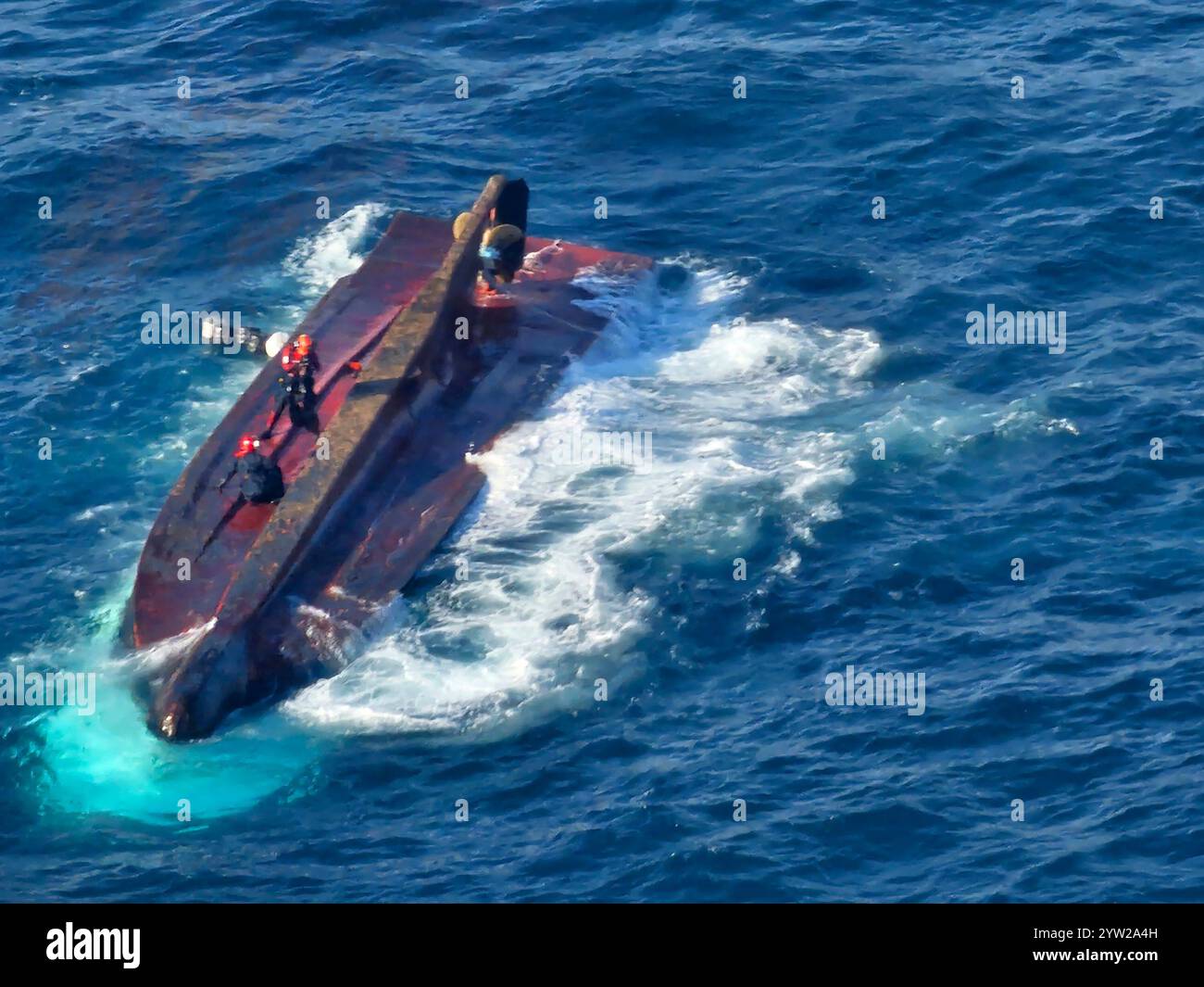 In this photo provided by South Korea Coast Guard, members of South Korean coast guard conduct a ...