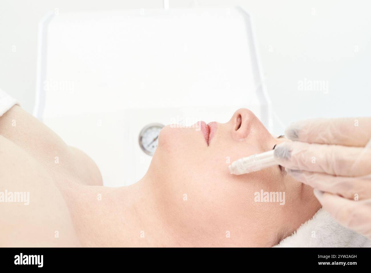 Caucasian female receiving skincare treatment in spa setting with ...