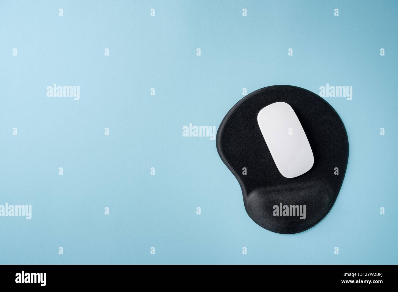 Top view of modern white mouse on black mousepad on blue table Stock ...