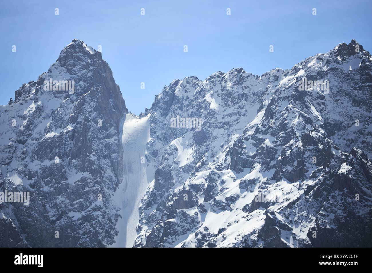 Snowy mountain peaks, rock. Extreme terrain, steep sheer slopes. Ala ...