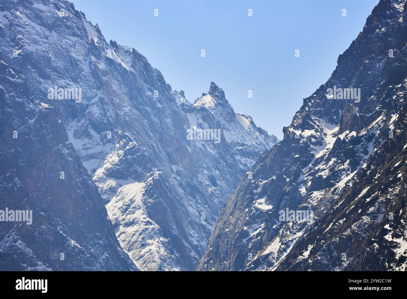 Snowy mountain peaks, rock. Extreme terrain, steep sheer slopes. Ala ...