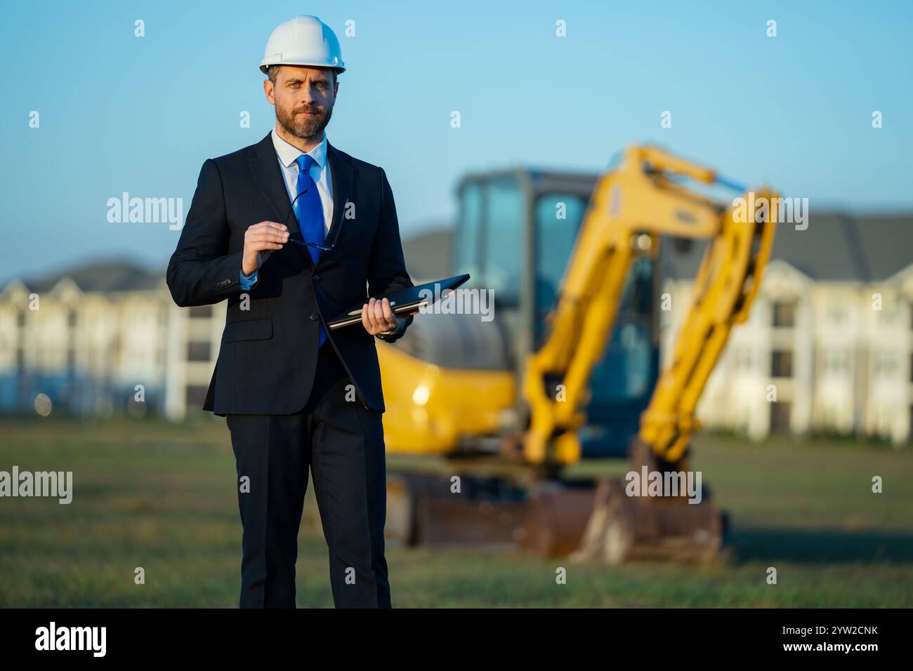 Successful construction business owner. Construction worker in suit and ...