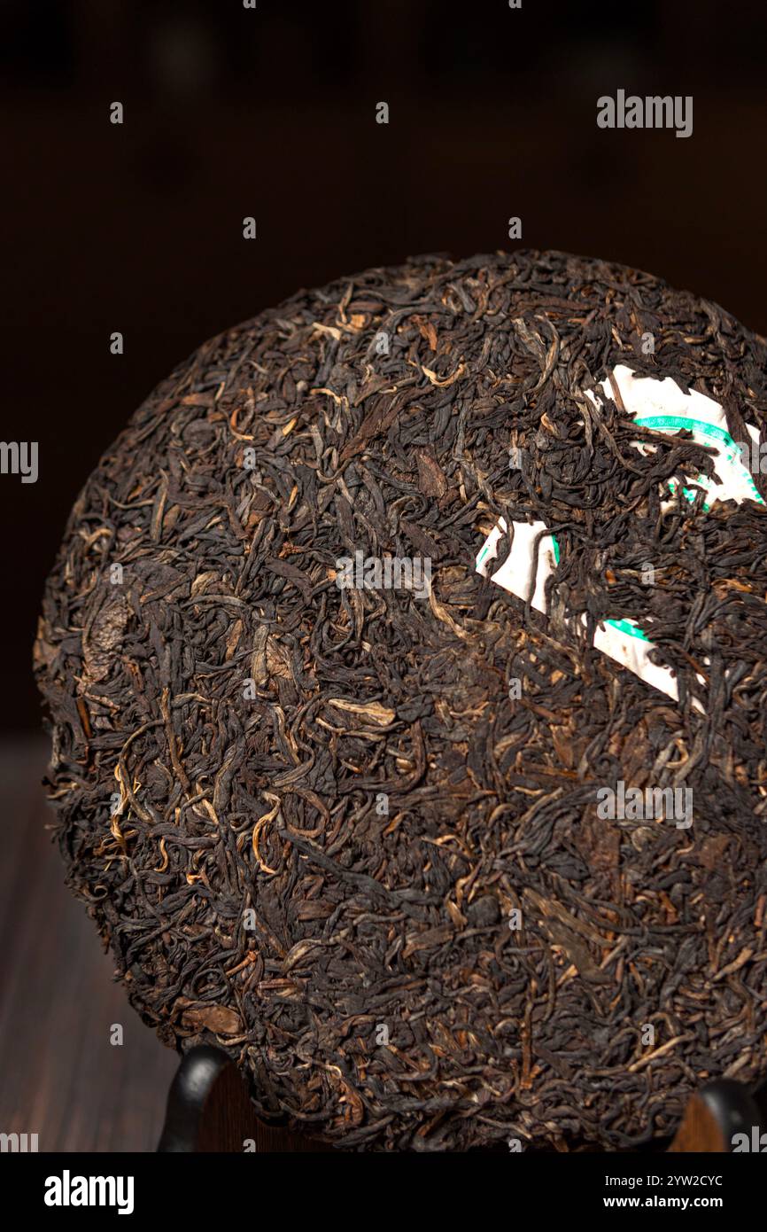 This is a detailed view of a round, compressed tea cake that ...