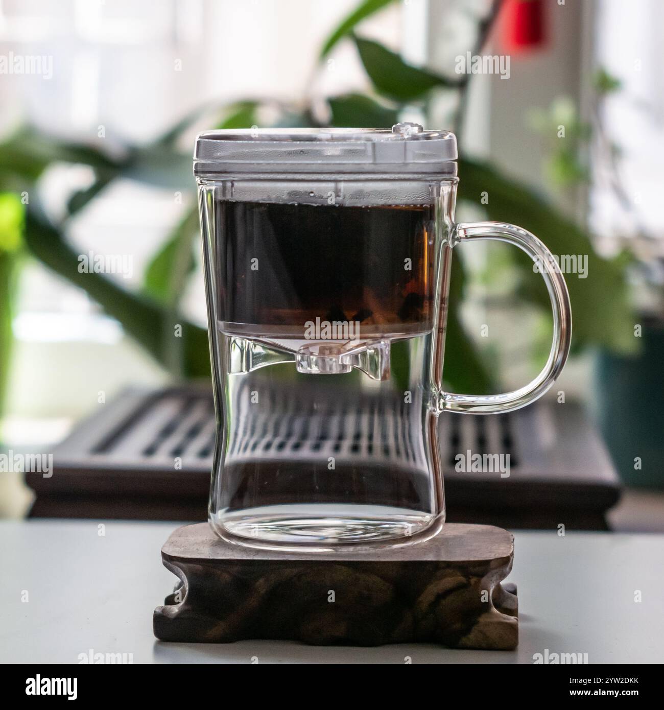 A stylish, modern glass coffee maker showcasing the rich, dark coffee ...
