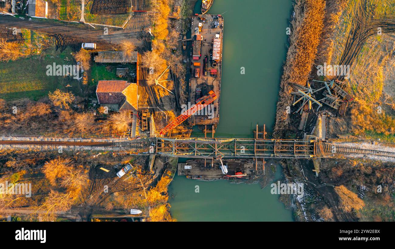 Above top view on workers are cutting old railroad bridge from cherry ...