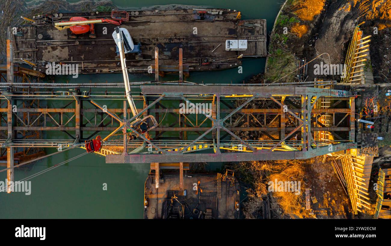 Above top view on workers are cutting old railroad bridge from cherry ...