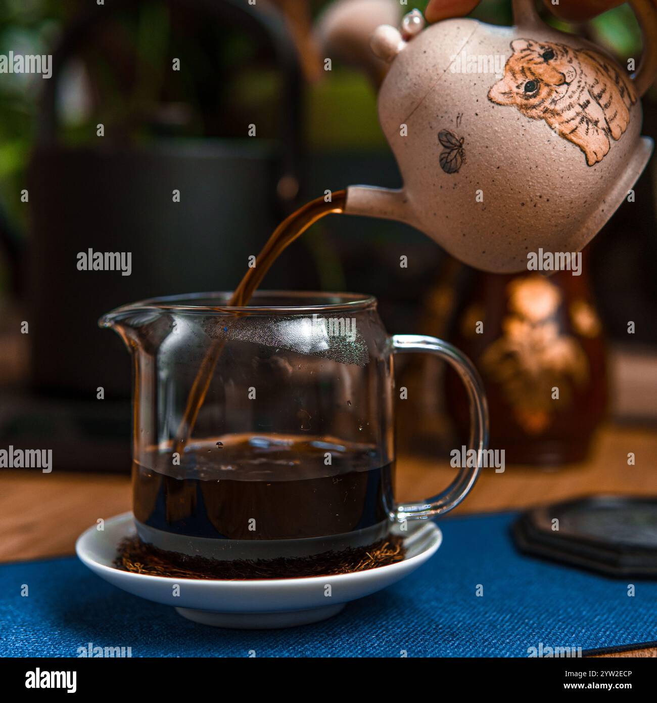 A traditional tea setup with a beautifully crafted pot and elegant ...