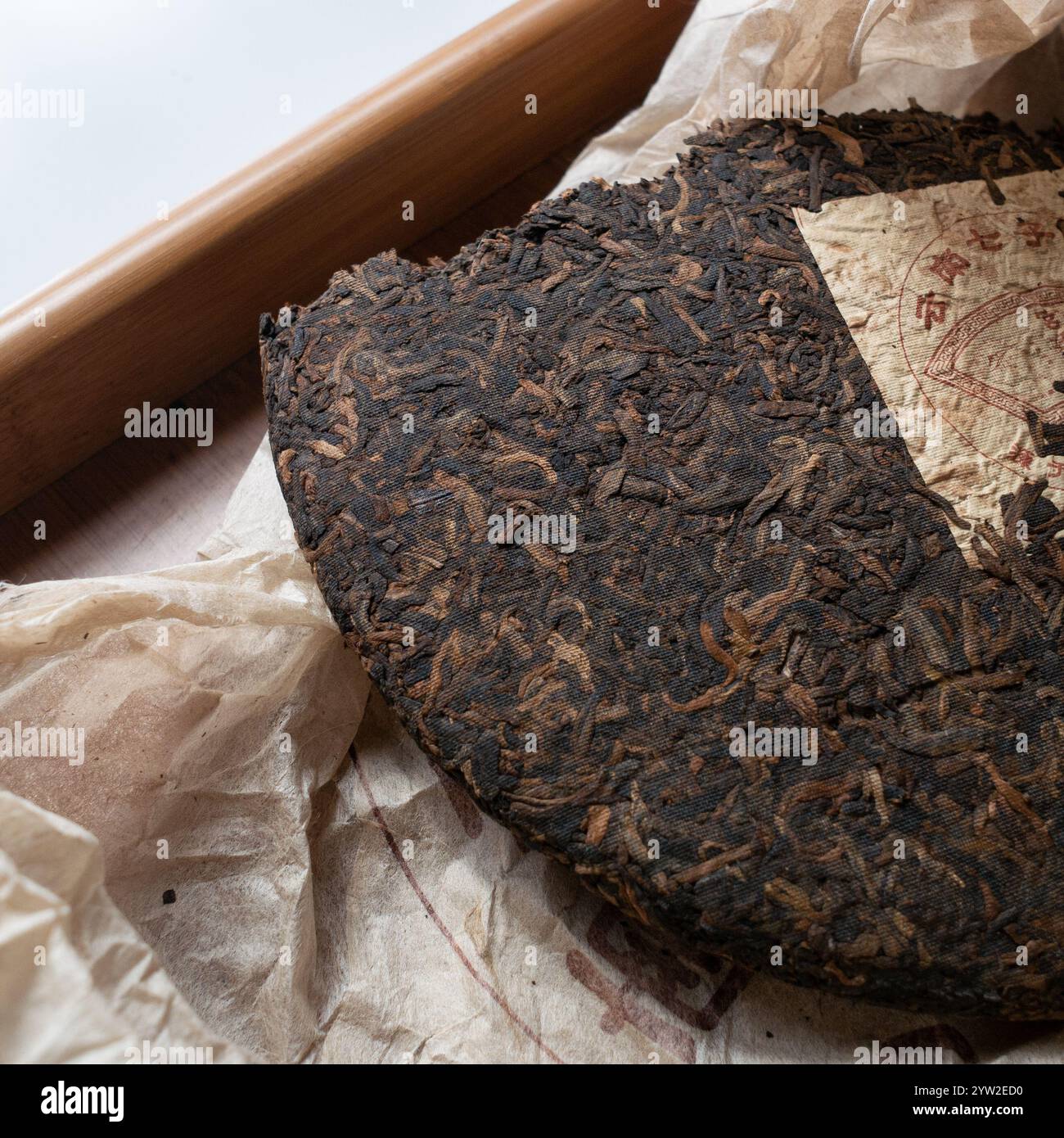 This is a detailed closeup image of a compressed Puerh tea cake ...