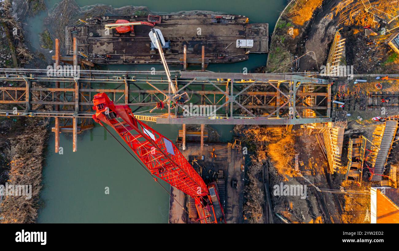 Above top view on workers are cutting old railroad bridge from cherry ...