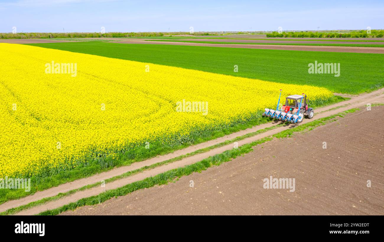 Above view tractor as dragging mounted as pulling mechanical seeder ...