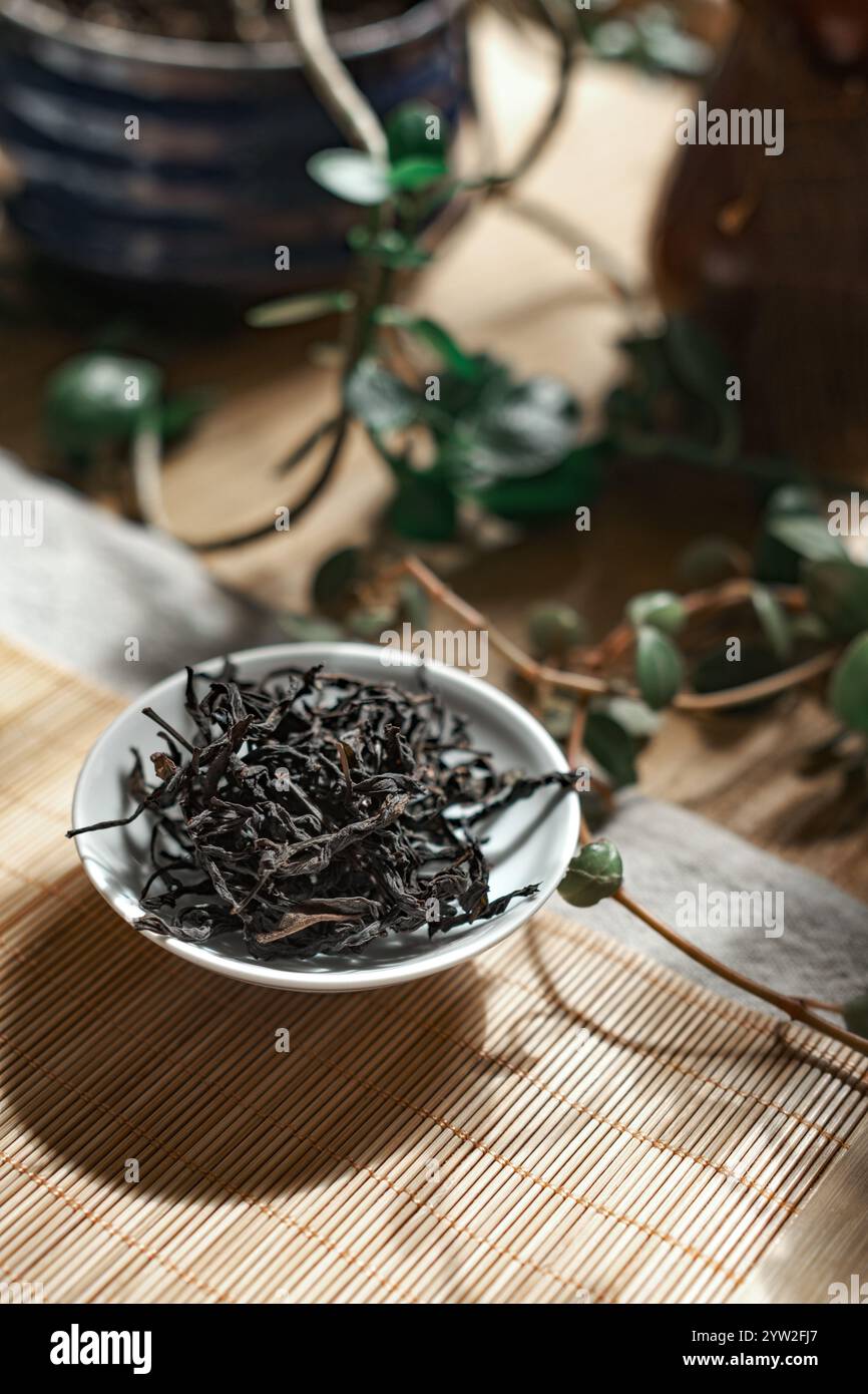 An elegant display of loose black tea leaves on a dish, ideal for tea ...