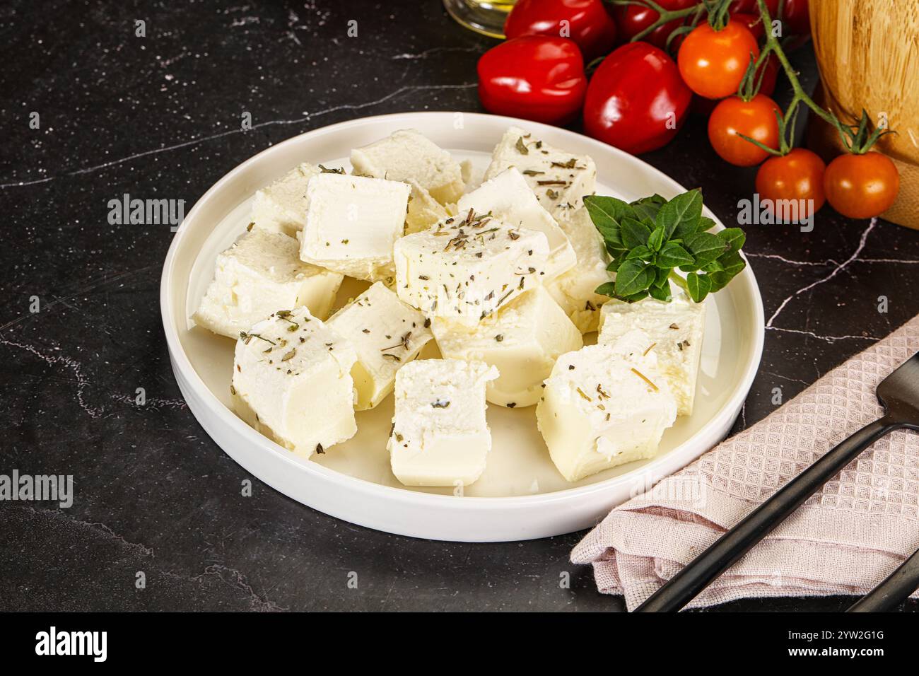 Greek traditional Feta cheese cubes with herbs and spices Stock Photo ...