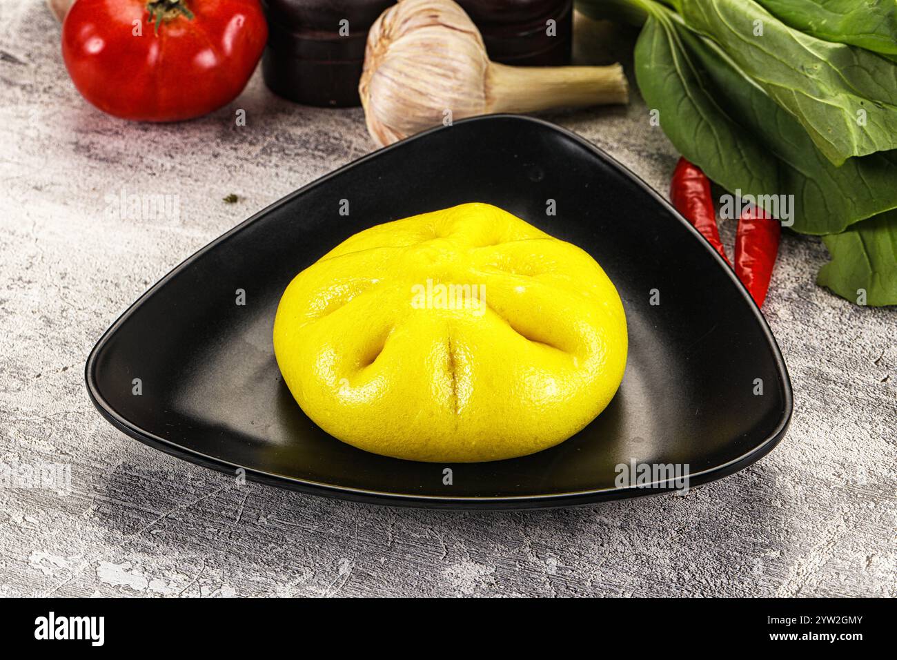 Asian stuffed steamed yellow Bun Bao Stock Photo - Alamy