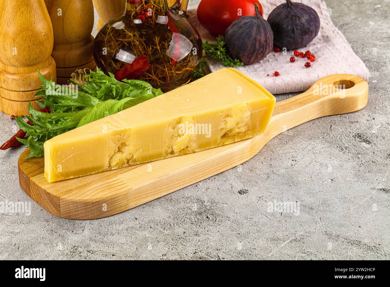 Hard parmesan cheese triangle over board served salad Stock Photo - Alamy