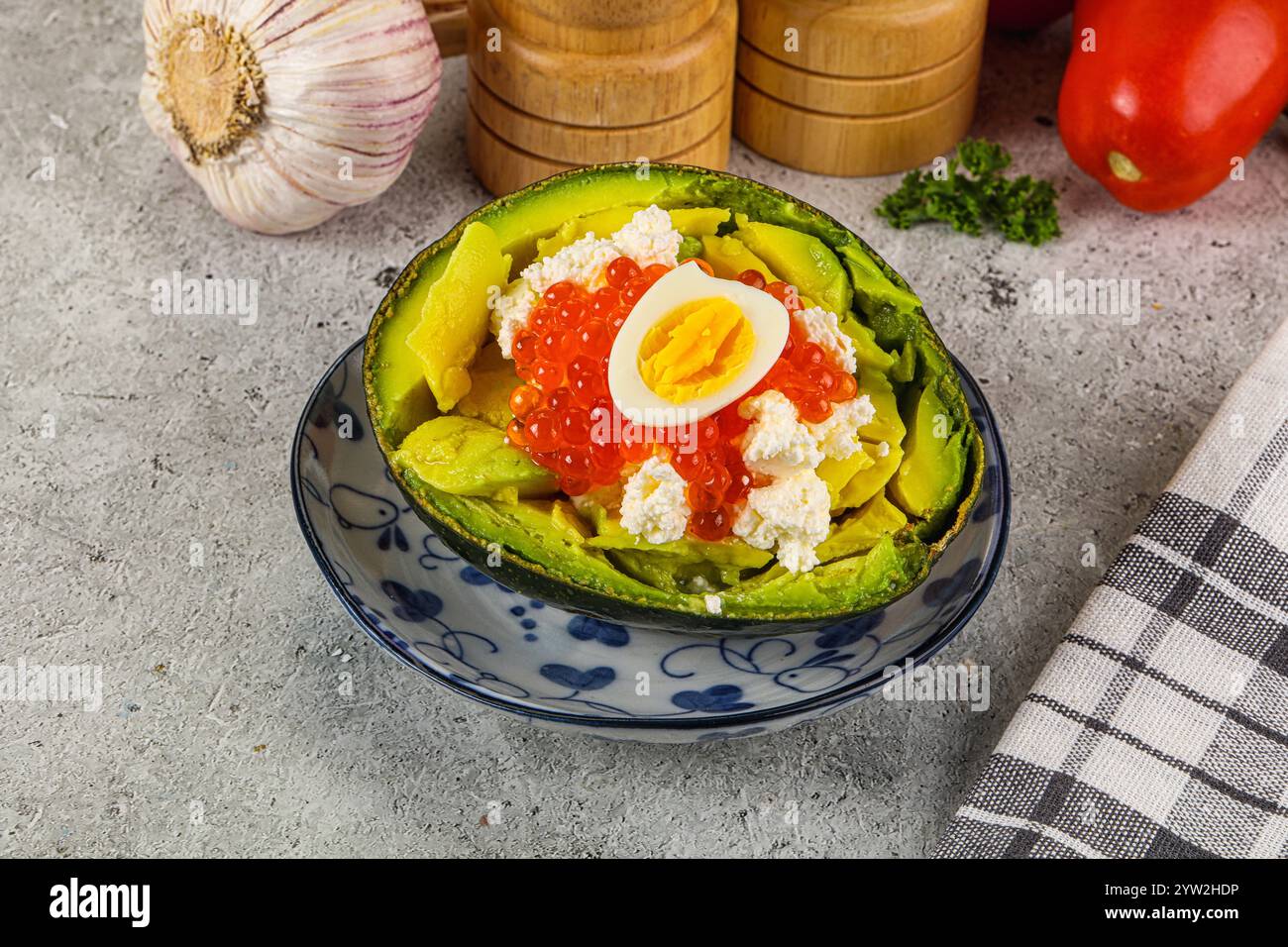 Avocado with red caviar and quil egg and soft cheese Stock Photo - Alamy