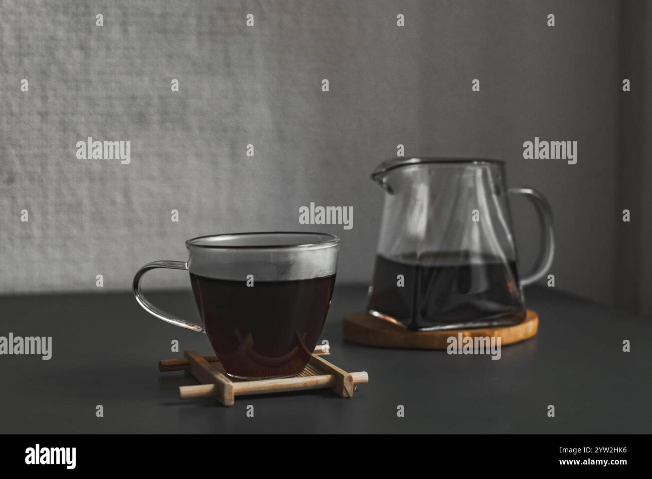 This chic photo features a coffee cup and a stylish pitcher, showcasing ...