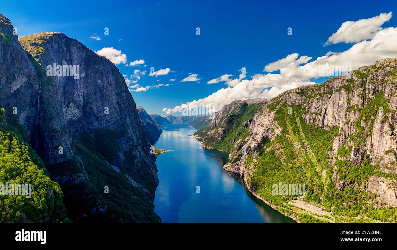 A breathtaking view of a Norwegian fjord, showcasing towering cliffs ...