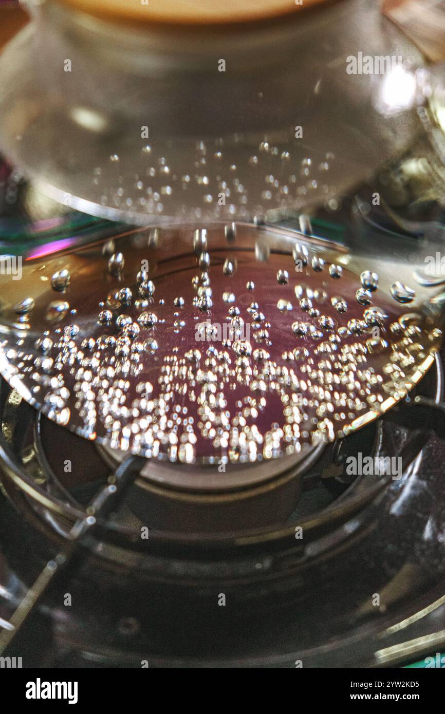 A detailed closeup of water actively boiling on a stove, revealing ...