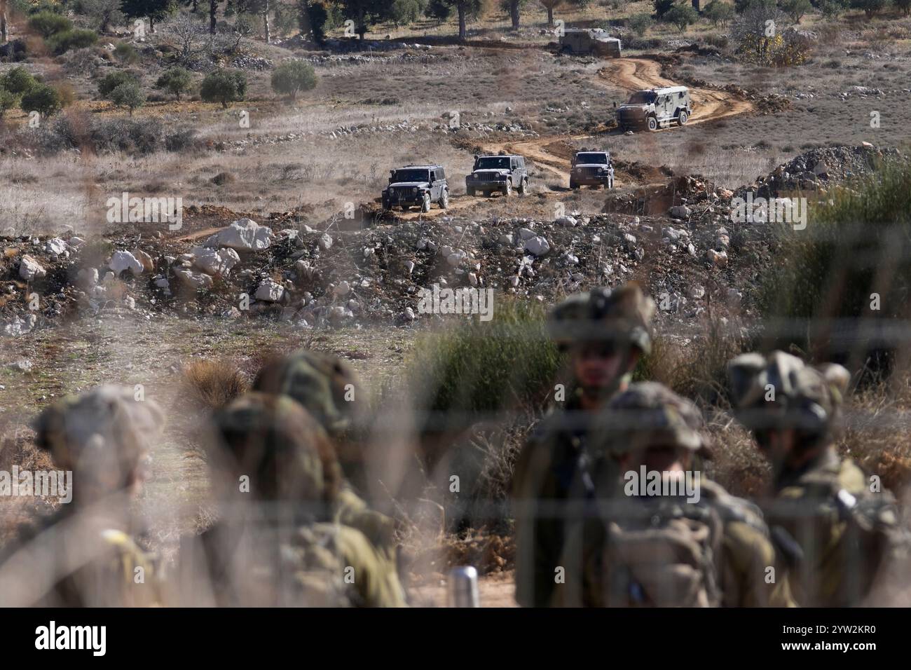 Israeli armored vehicles maneuver near the so-called Alpha Line that ...
