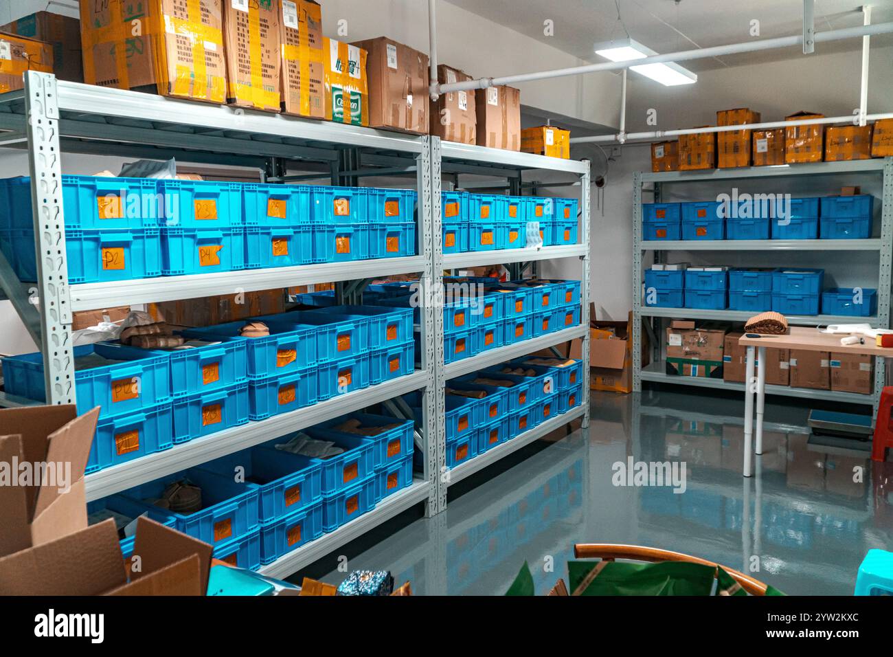 A wellorganized and efficient storage room featuring tidy blue bins and ...