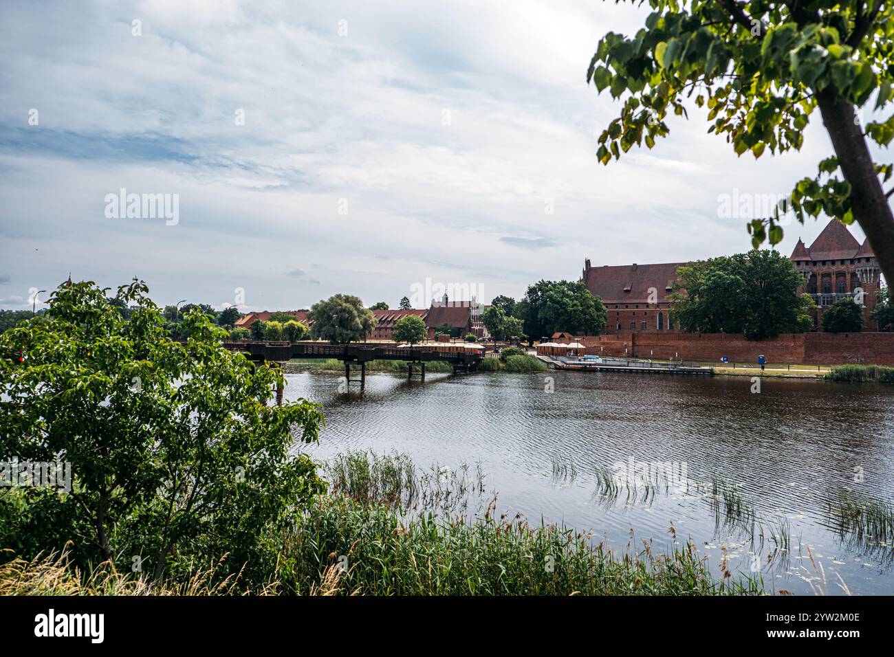 Malbork Castle by the Nogat River with medieval red brick architecture ...