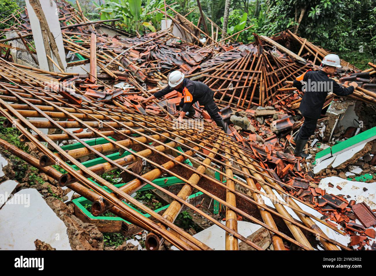 Rescuers clear up rubble from damaged houses at a neighborhood affected ...