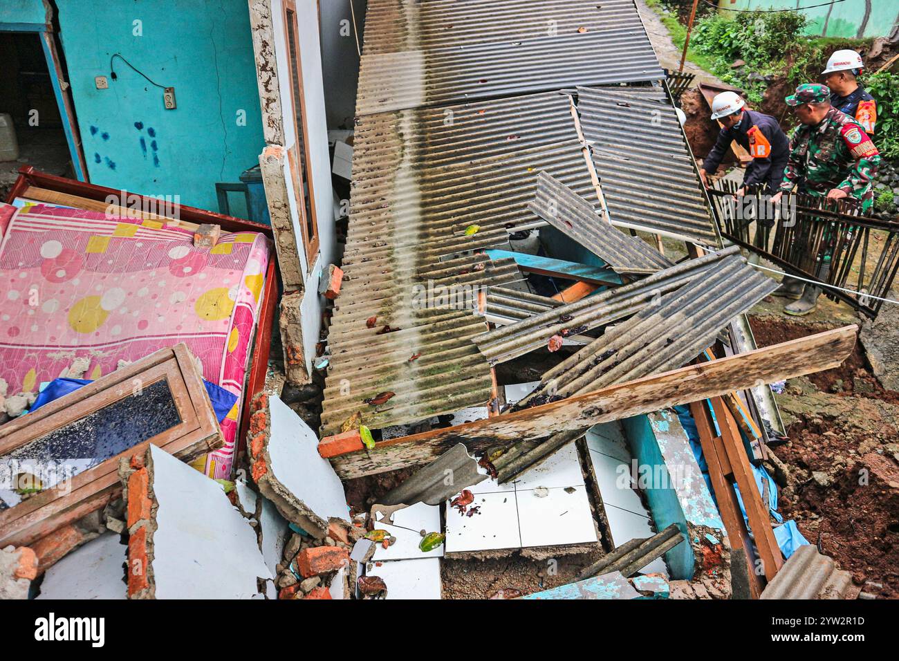 Rescuers clear up rubble from damaged houses at a neighborhood affected ...