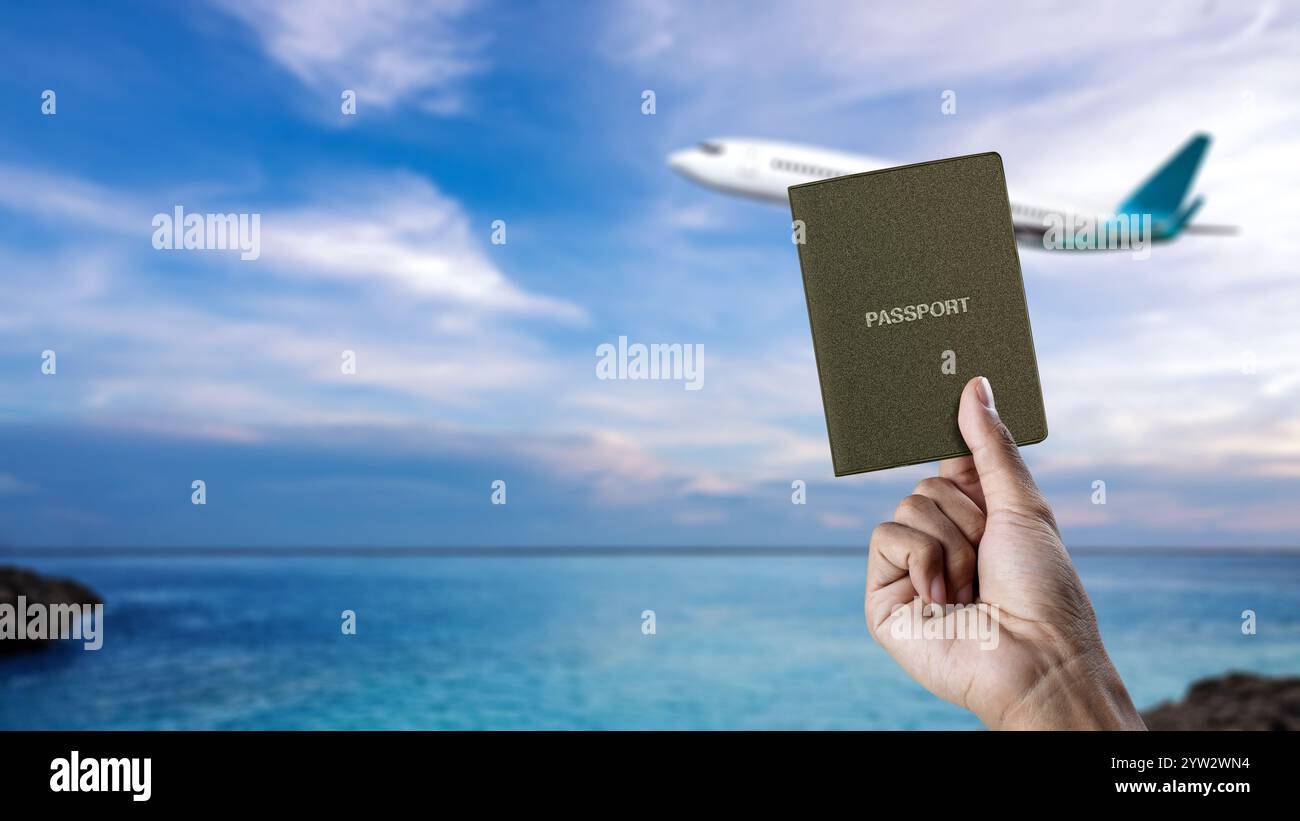 Human hand holding a passport with flying commercial airplane in the ...