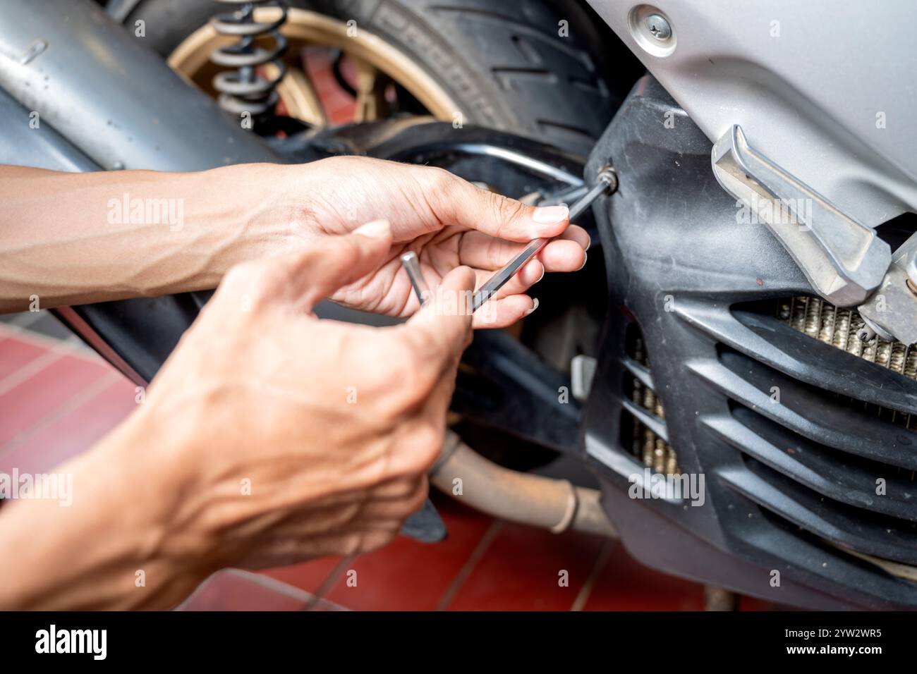 Motorcycle mechanic repairing the motorcycle at garage. Motorcycle ...