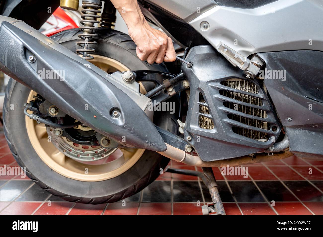 Motorcycle mechanic repairing the motorcycle at garage. Motorcycle ...