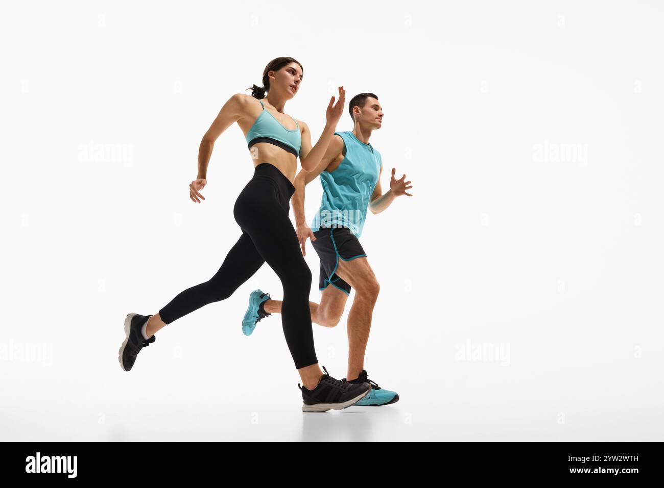 Low angle side view image of young athletic woman and muscular man in ...