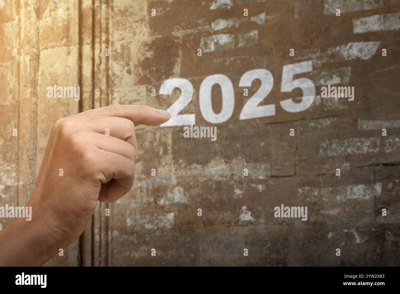 Human hand showing number of 2025 on the wall. Happy New Year concept ...