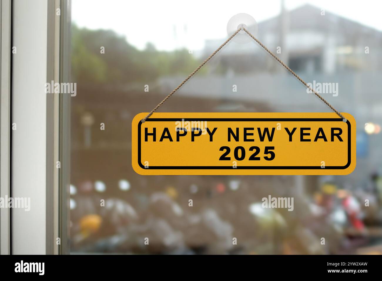 Hanging sign with text of Happy New Year 2025 on the window glass ...