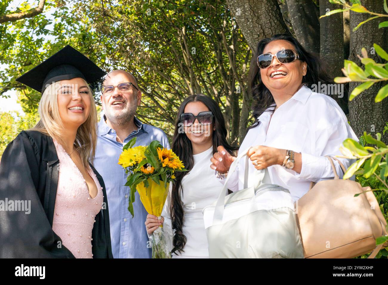 Smiling parents siblings holding hi-res stock photography and images ...
