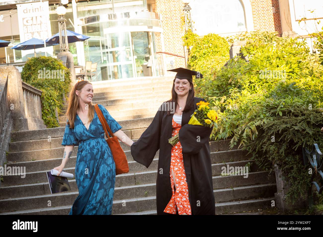 Two happy graduates in caps hi-res stock photography and images - Alamy