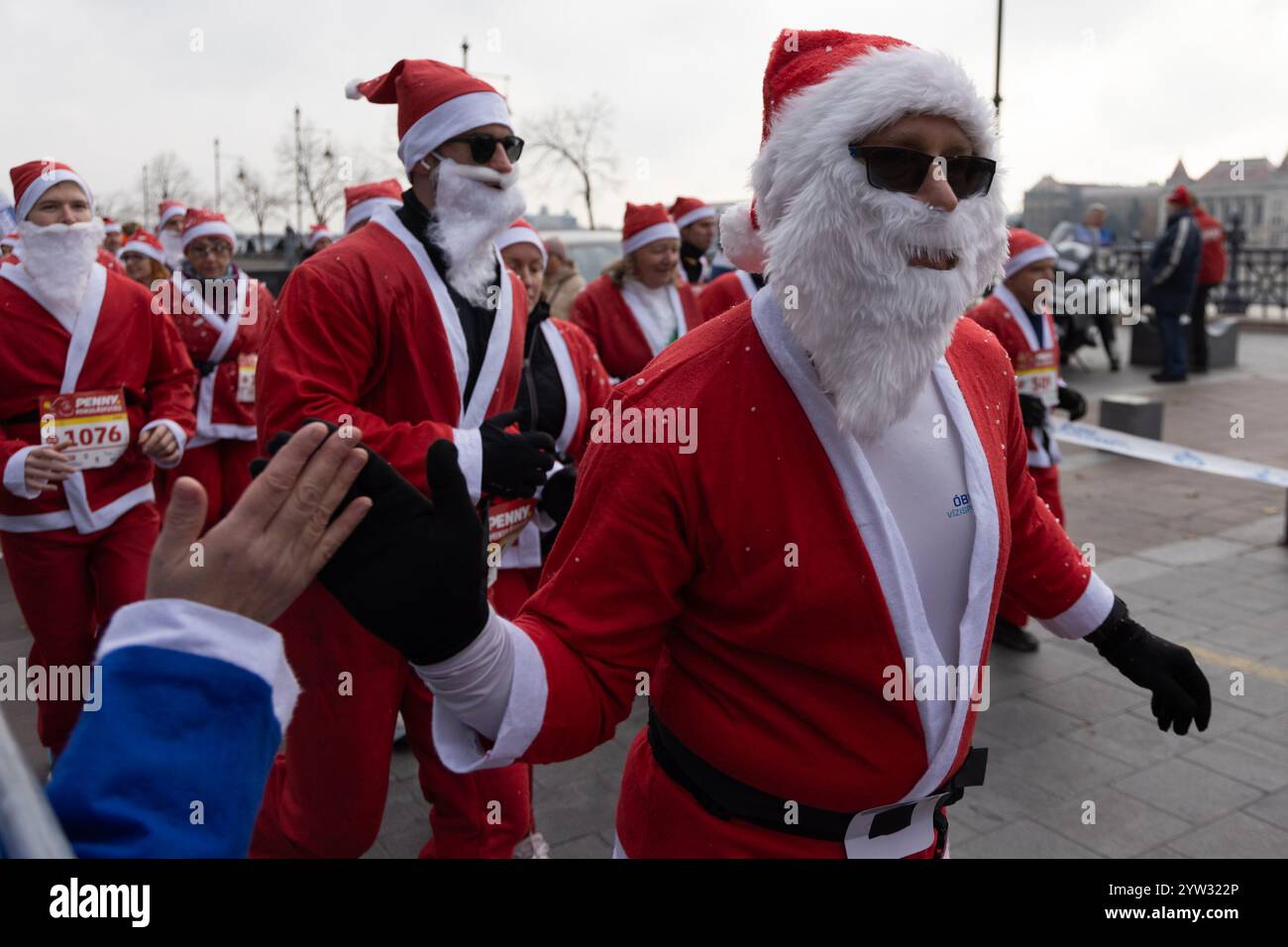 Budapest. 8th Dec, 2024. People in Santa Claus costumes participate in ...