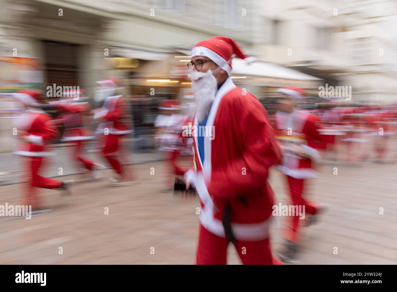Budapest. 8th Dec, 2024. People in Santa Claus costumes participate in ...