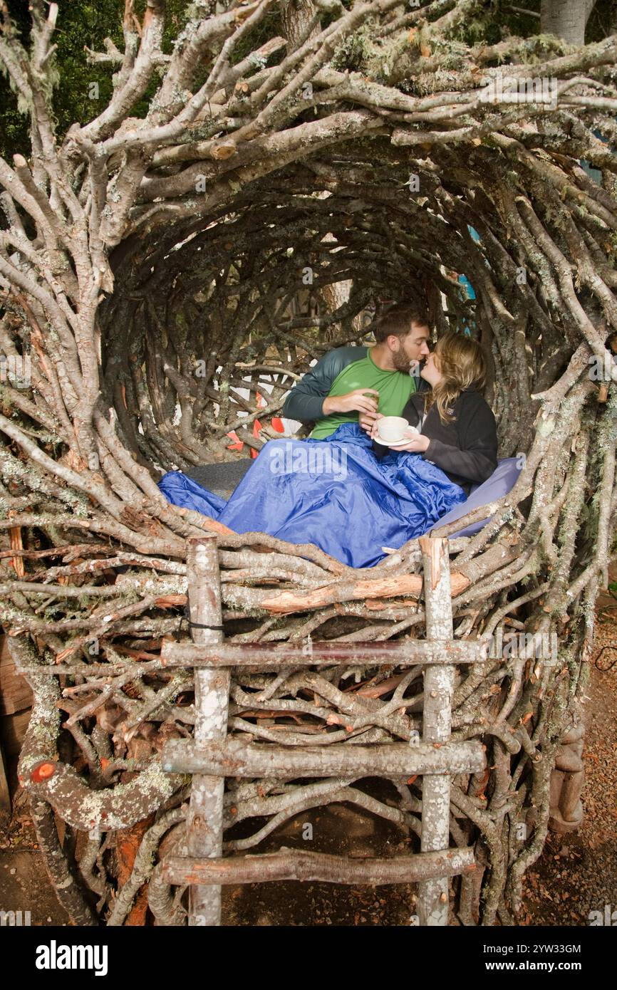 Couple relaxing in a spirit nest Stock Photo - Alamy
