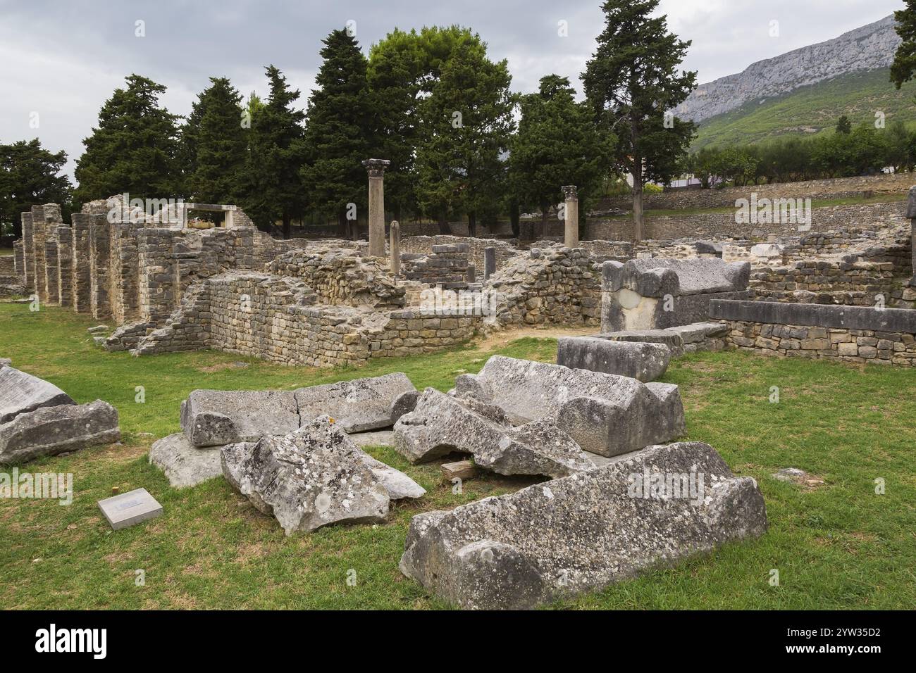 Old large and heavy broken pieces of cut and carved grey granite blocks ...